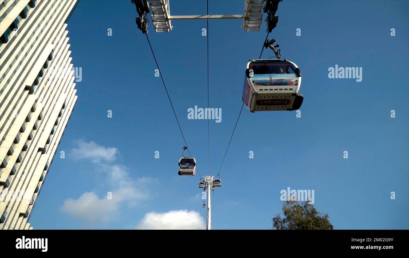 Modern cable car with cabins on blue sky background. Action. Beautiful ...