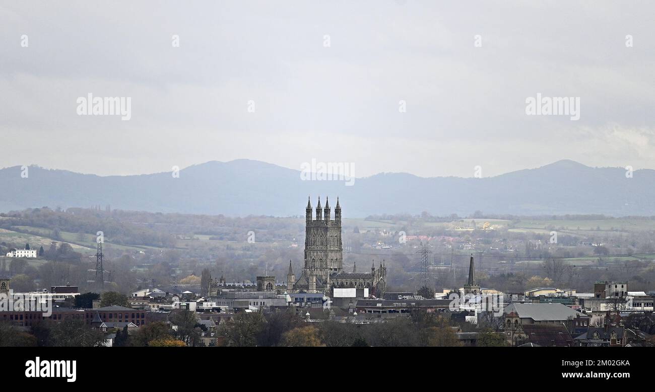 A view of Gloucester Cathedral with hills in the background during a ...