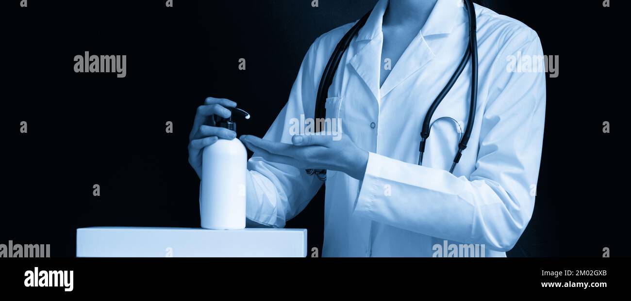 doctor applying antibacterial spray on hand on black background Stock ...