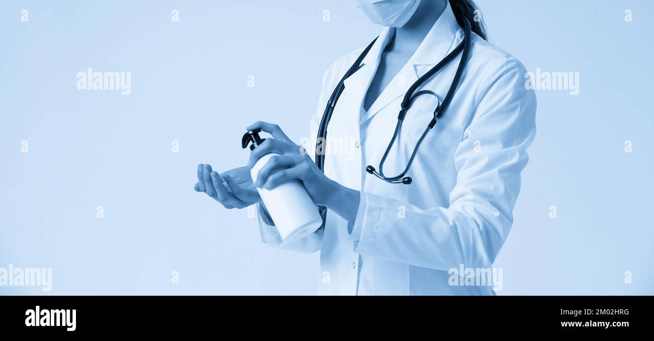 doctor applying antibacterial spray on hand on white background Stock ...