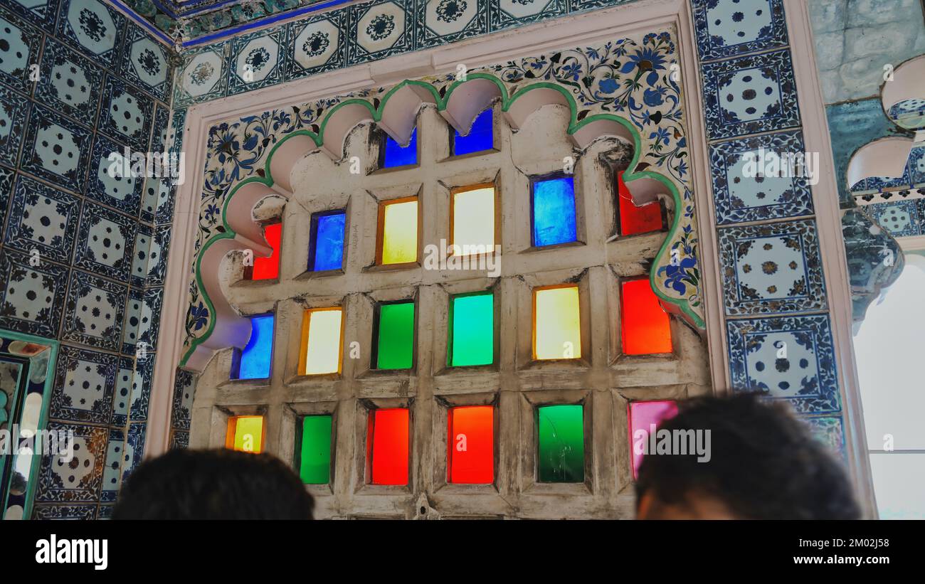 City Palace colorful window view in Udaipur, Rajasthan, India. People ...