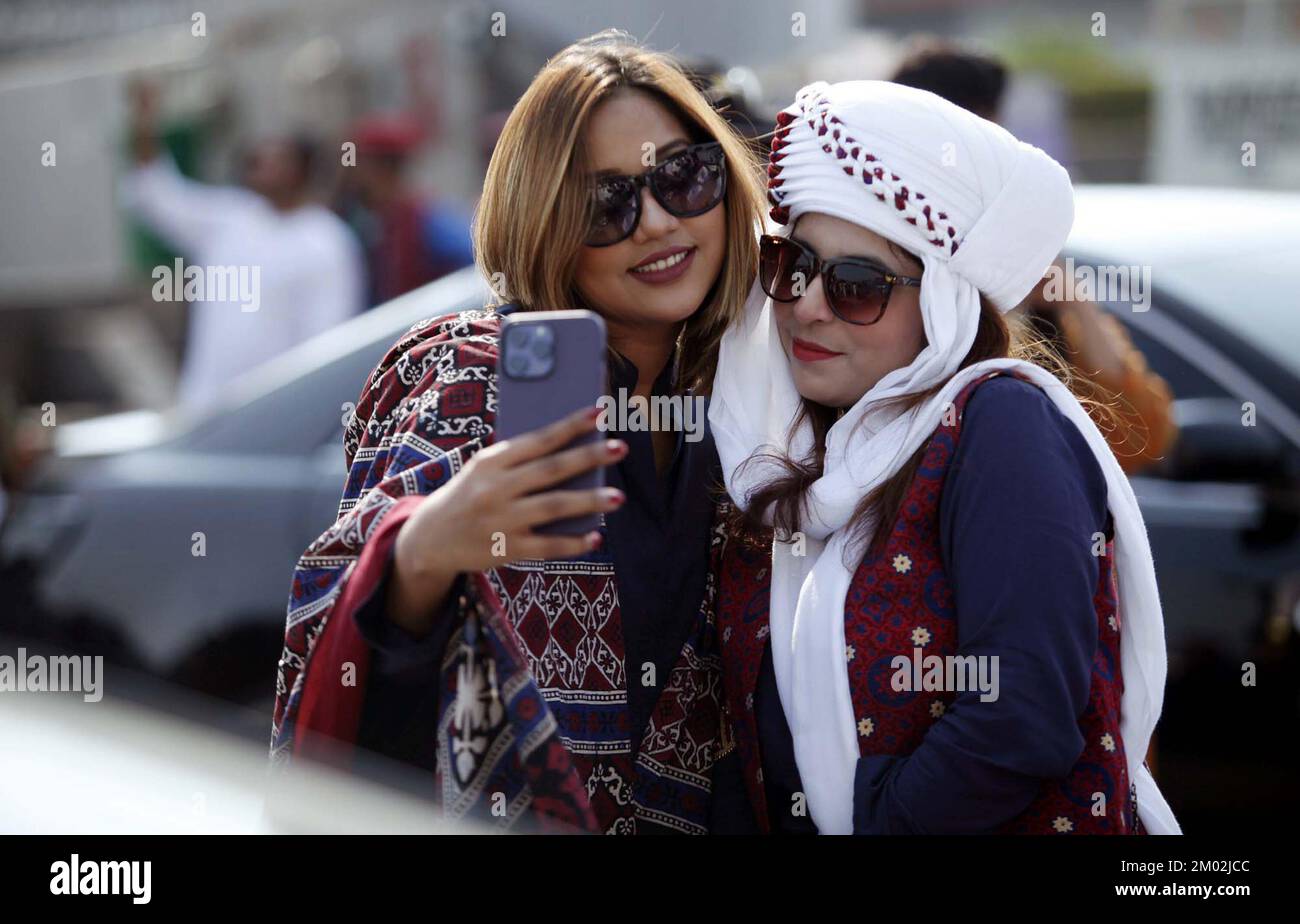 People are wearing Sindh traditional dresses as they holding ...