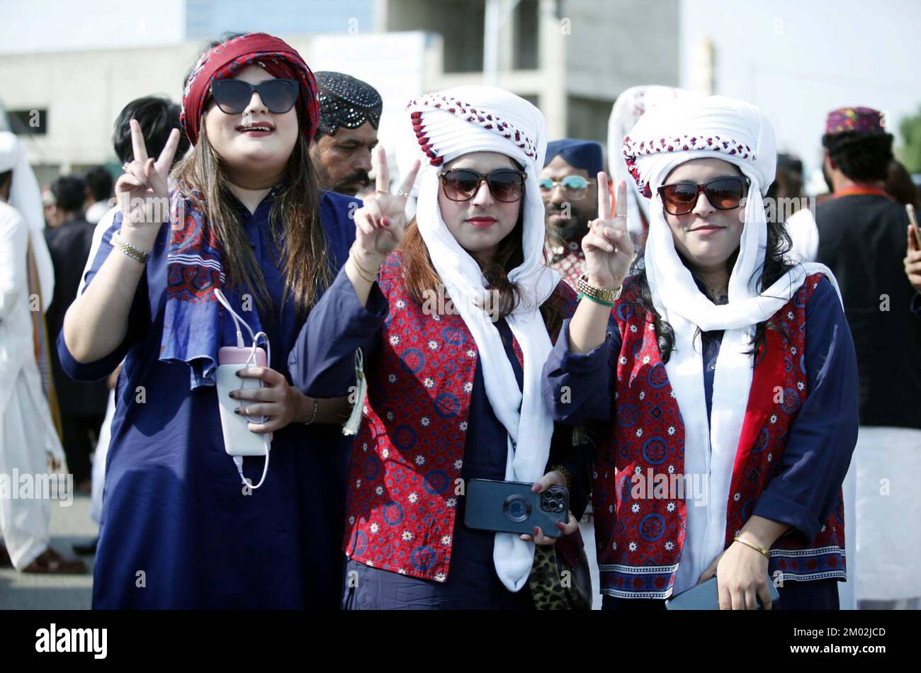 People are wearing Sindh traditional dresses as they holding ...