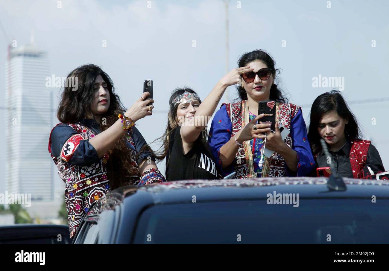 People are wearing Sindh traditional dresses as they holding ...