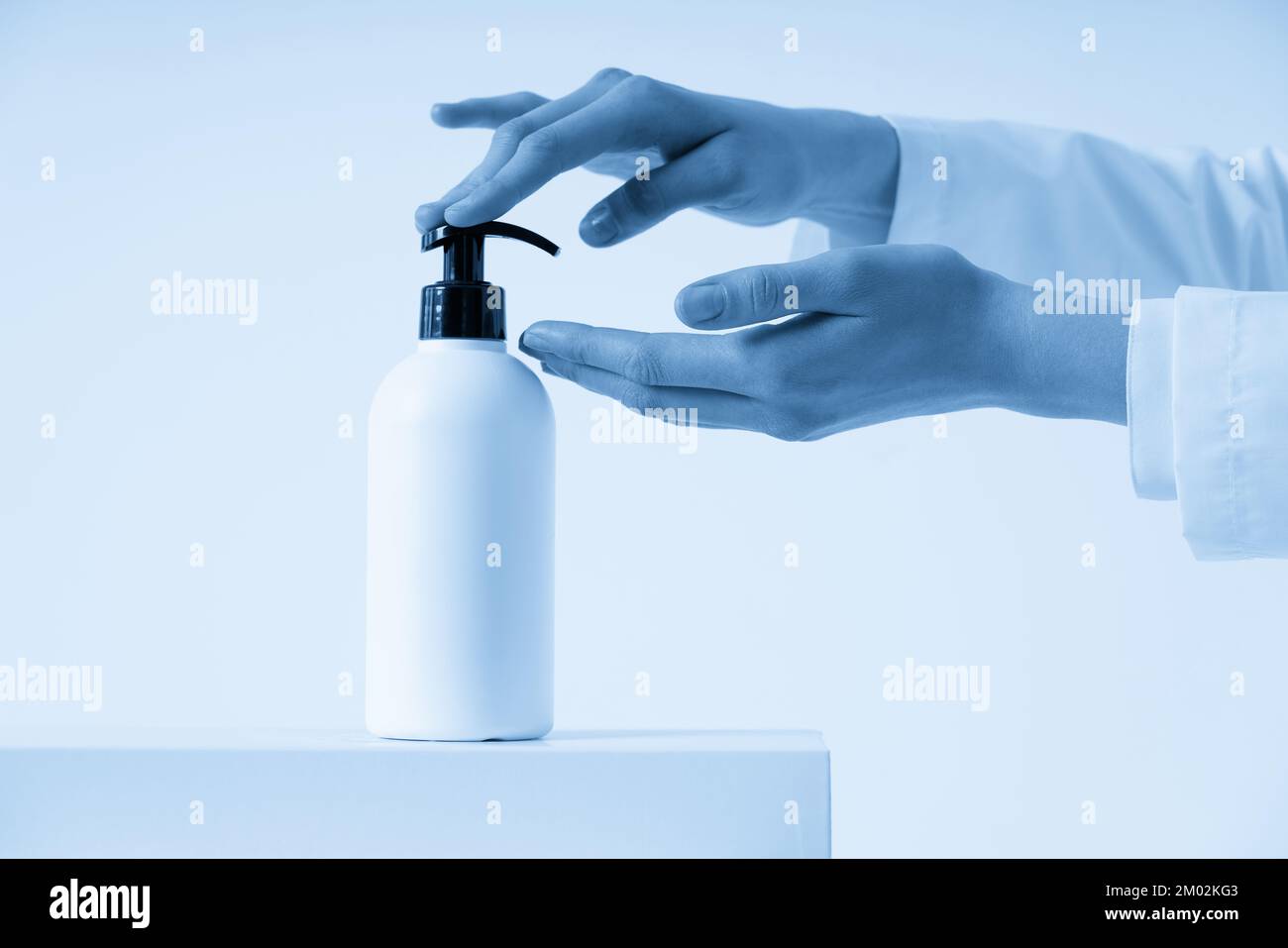 Woman hands pushing pump plastic soap bottle with copy space, using ...
