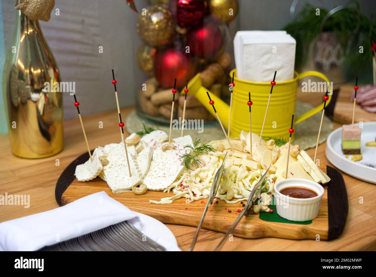 Different varieties of cheese on a wooden board, cold appetizers on the ...