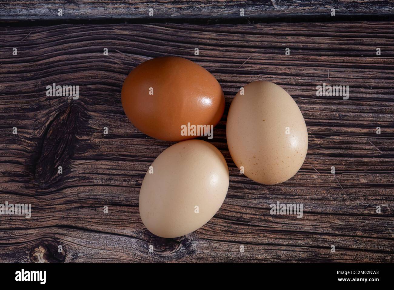 Chicken eggs on a wooden table Stock Photo - Alamy