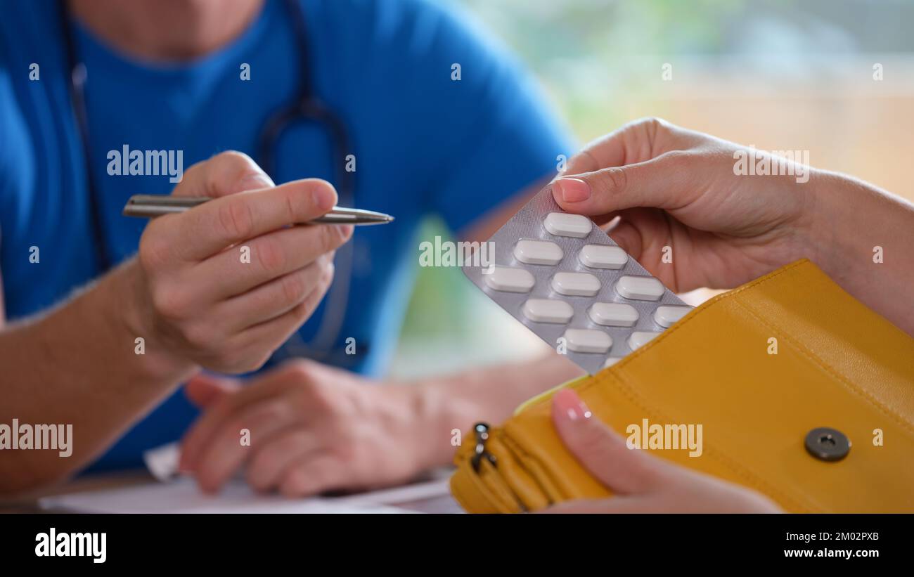 Male doctor gives prescription for pills to woman in his clinic Stock ...