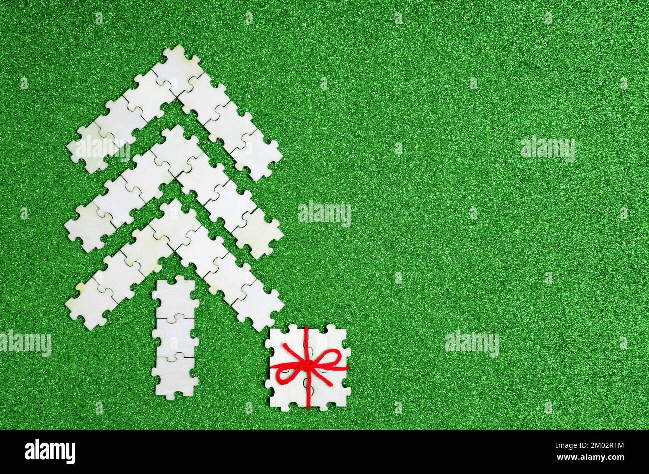 Christmas tree shape and a gift box made from wooden jigsaw puzzle ...