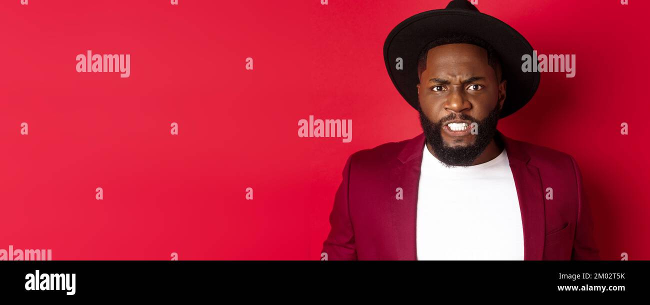 Tensed african american man clench teeth and frowning, looking at ...