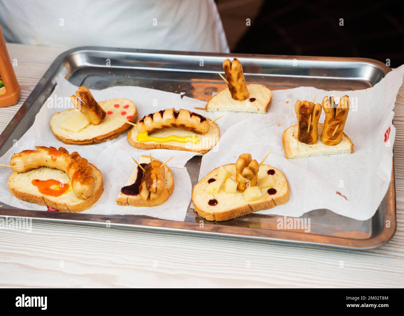 Hot Dog with different condiments and chilli peppers and tomatoes and ...