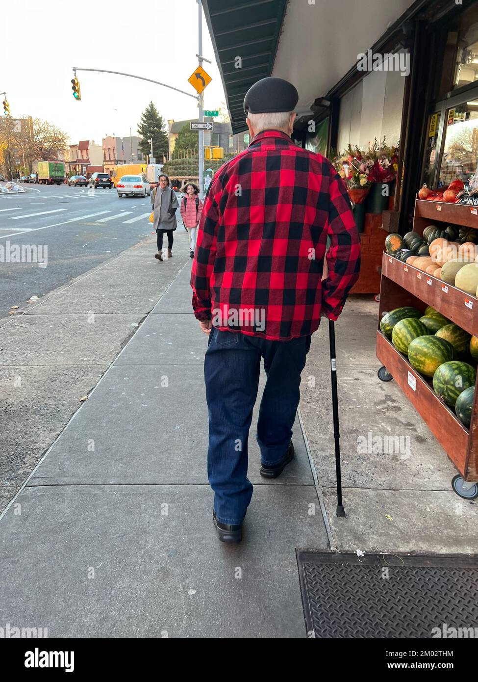 Old gentleman, walking with a cane, out shopping along 7th Avenue in ...