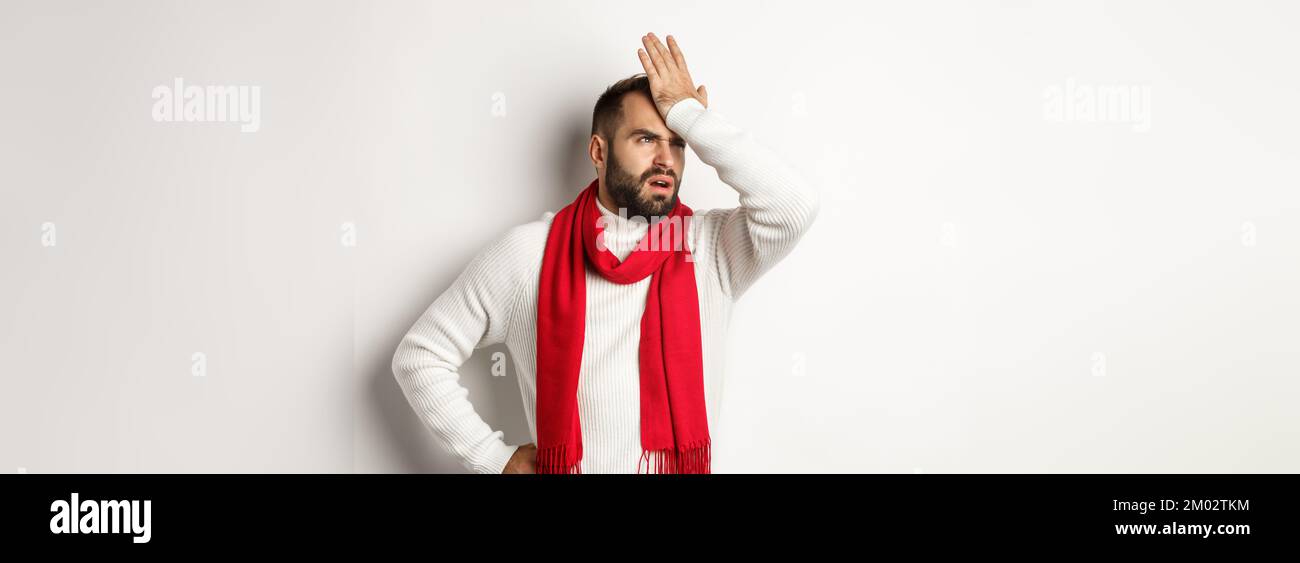 Annoyed man slap his forehead and cursing, forgetting buy christmas ...