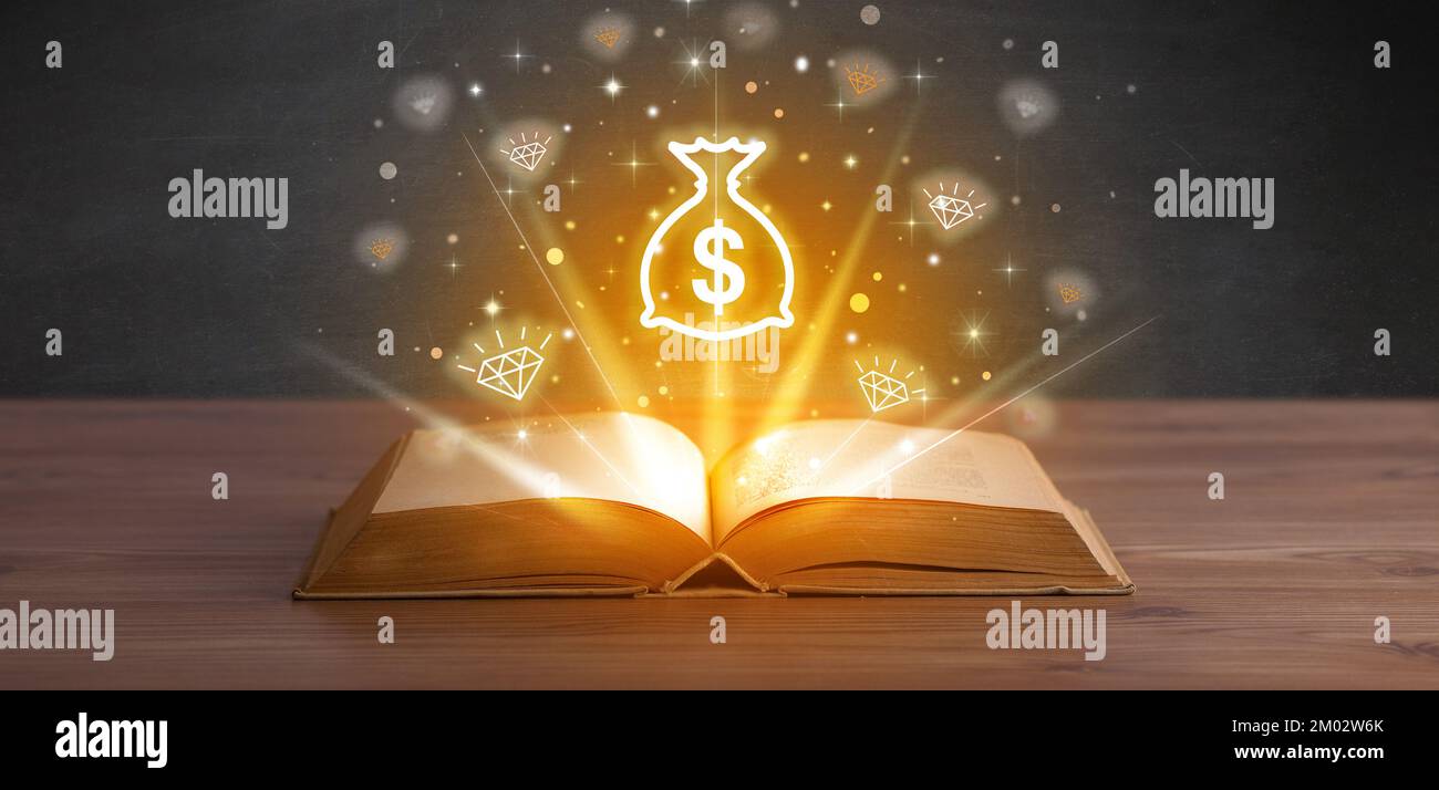 Open book with currency icons above Stock Photo - Alamy