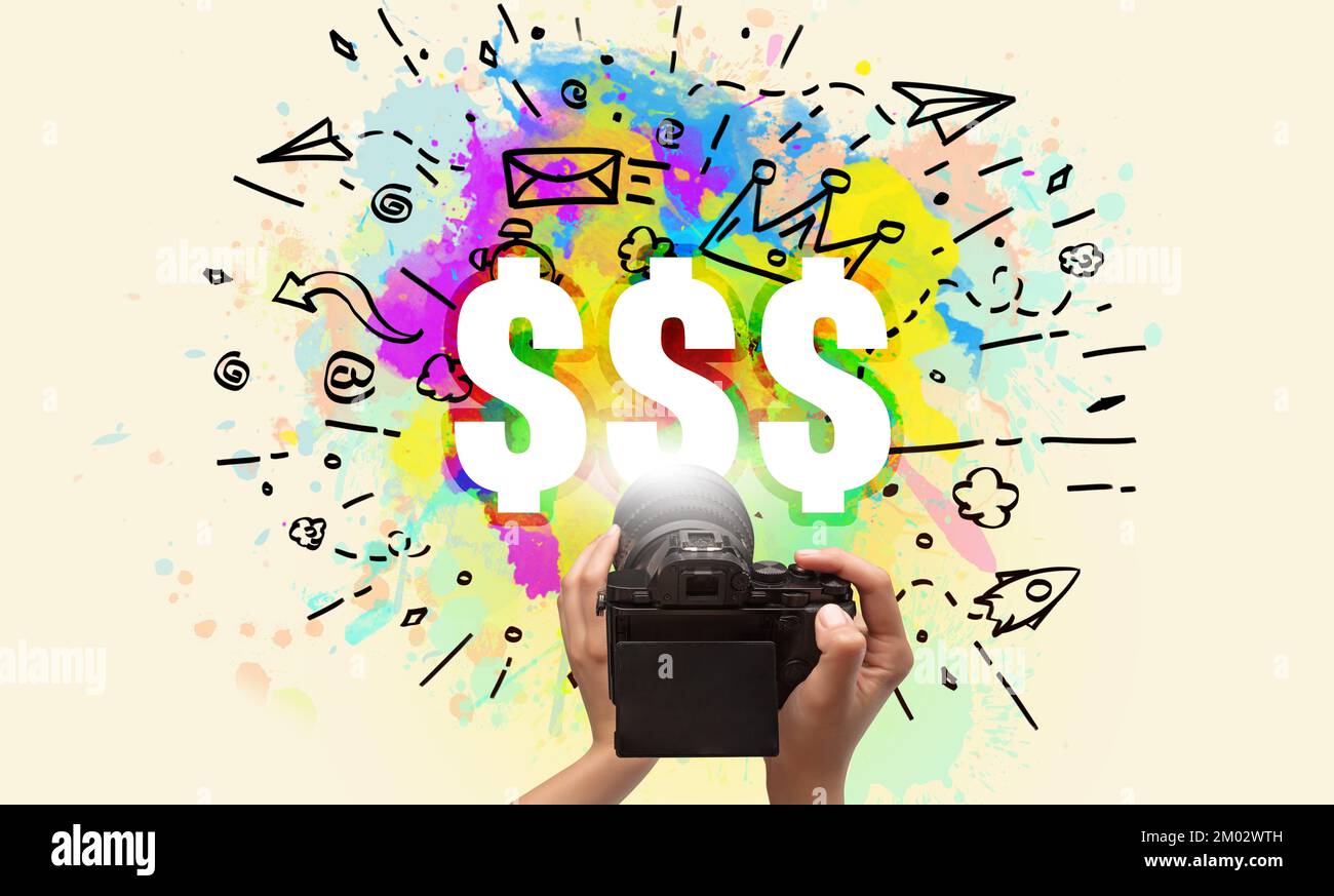 Close-up of a hand holding digital camera with abstract drawing concept ...