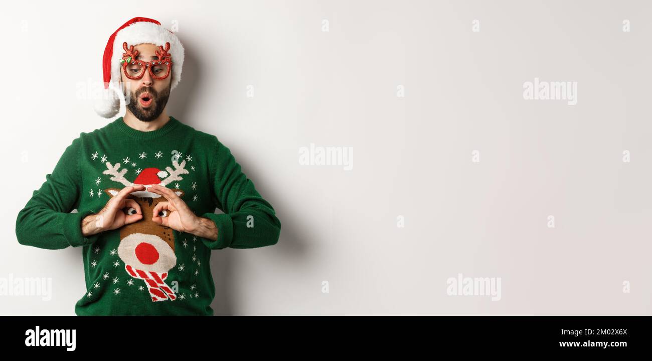 Christmas holidays, celebration concept. Happy guy in Santa hat and ...