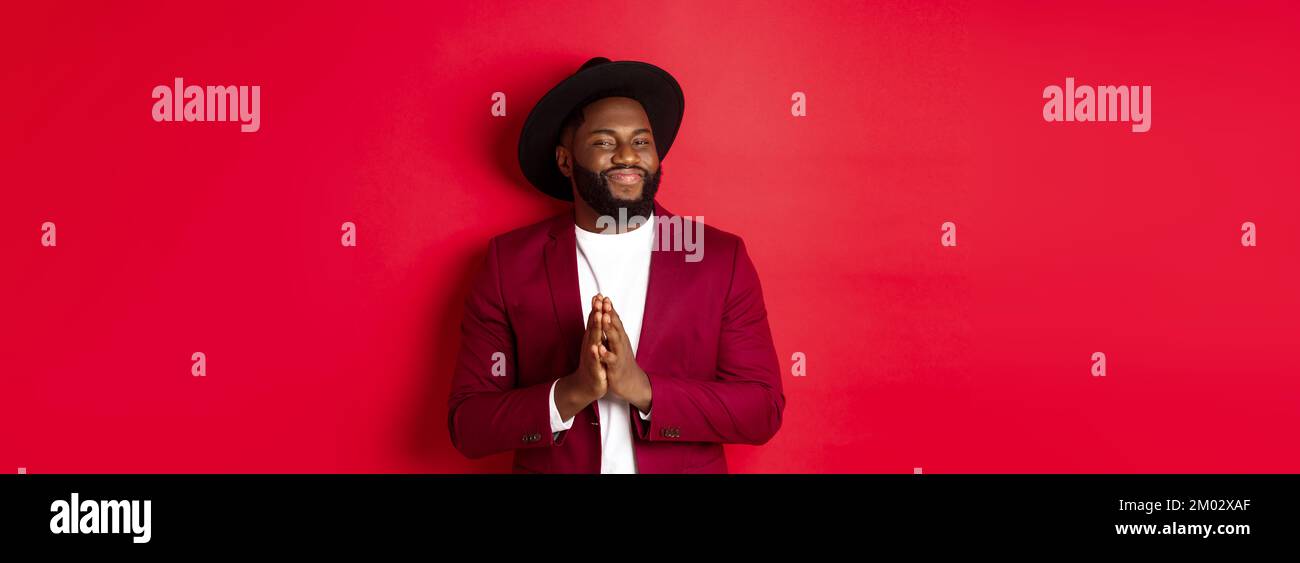 Handsome successful Black man relish profit, rub hands and smiling ...