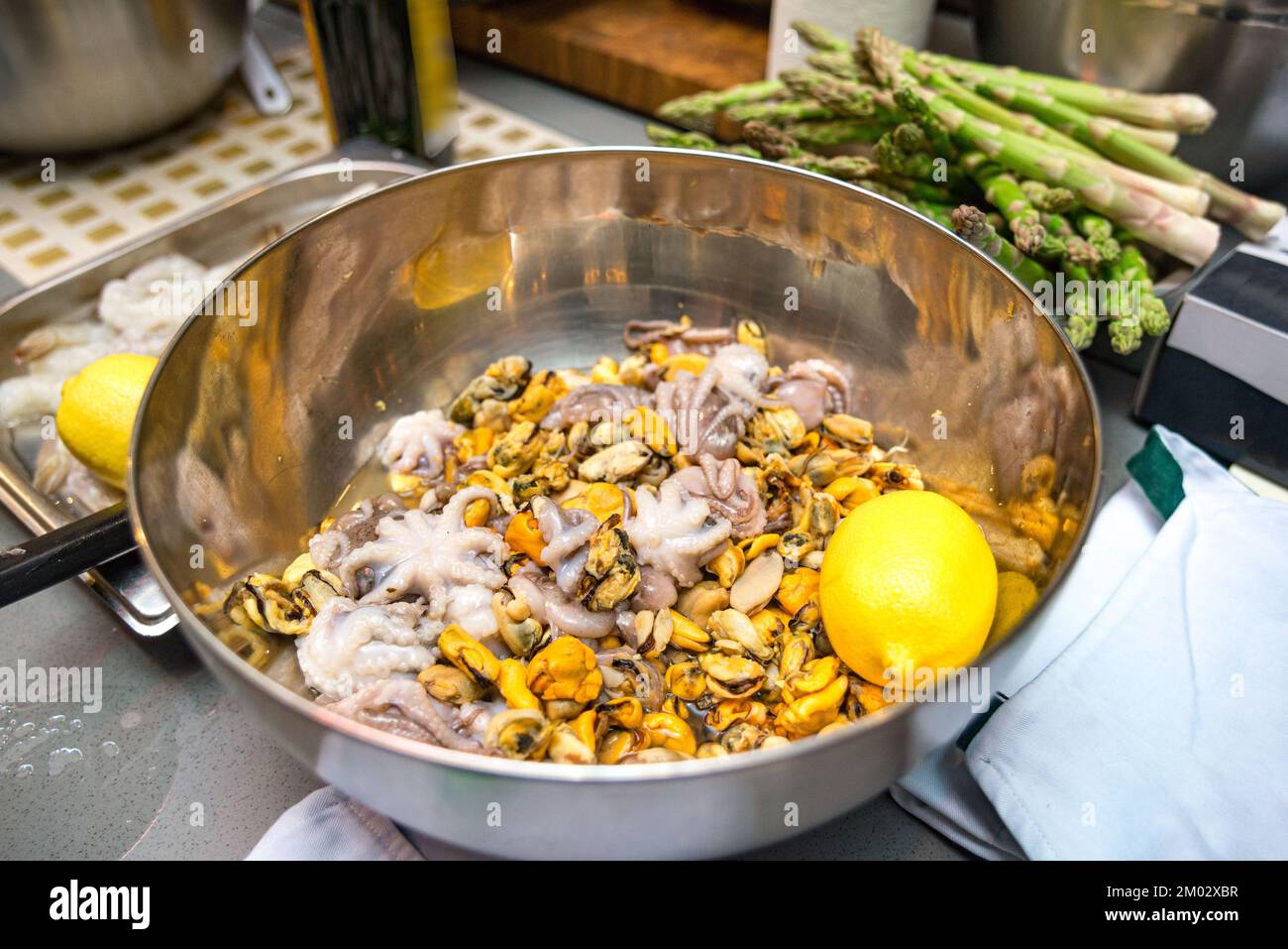 The seafood cocktail is defrosted in a metal bowl. Bunch of Mussels ...