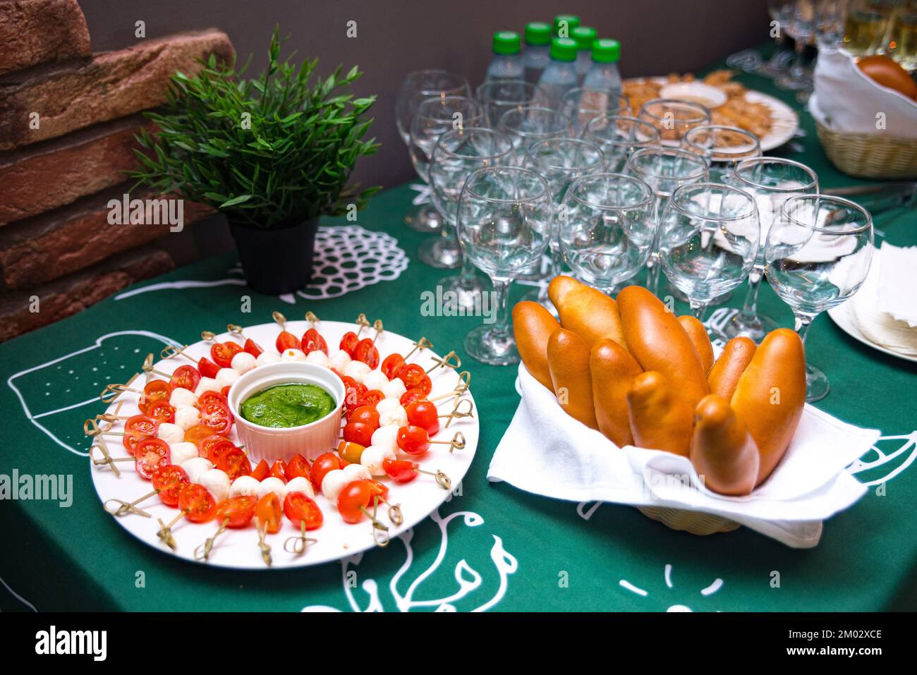 A table of appetizers. Russian pies, a plate of mini mozzarella canapés ...