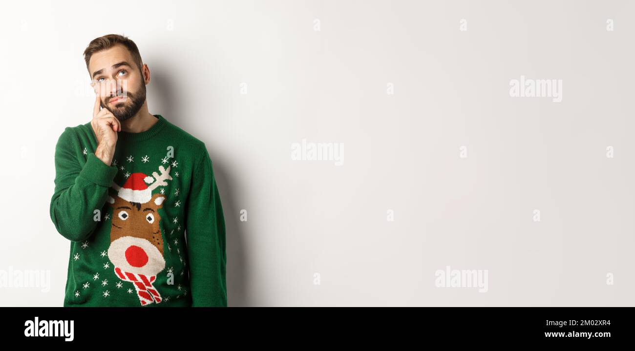 New Year, holidays and celebration. Sad young man with beard, wearing ...