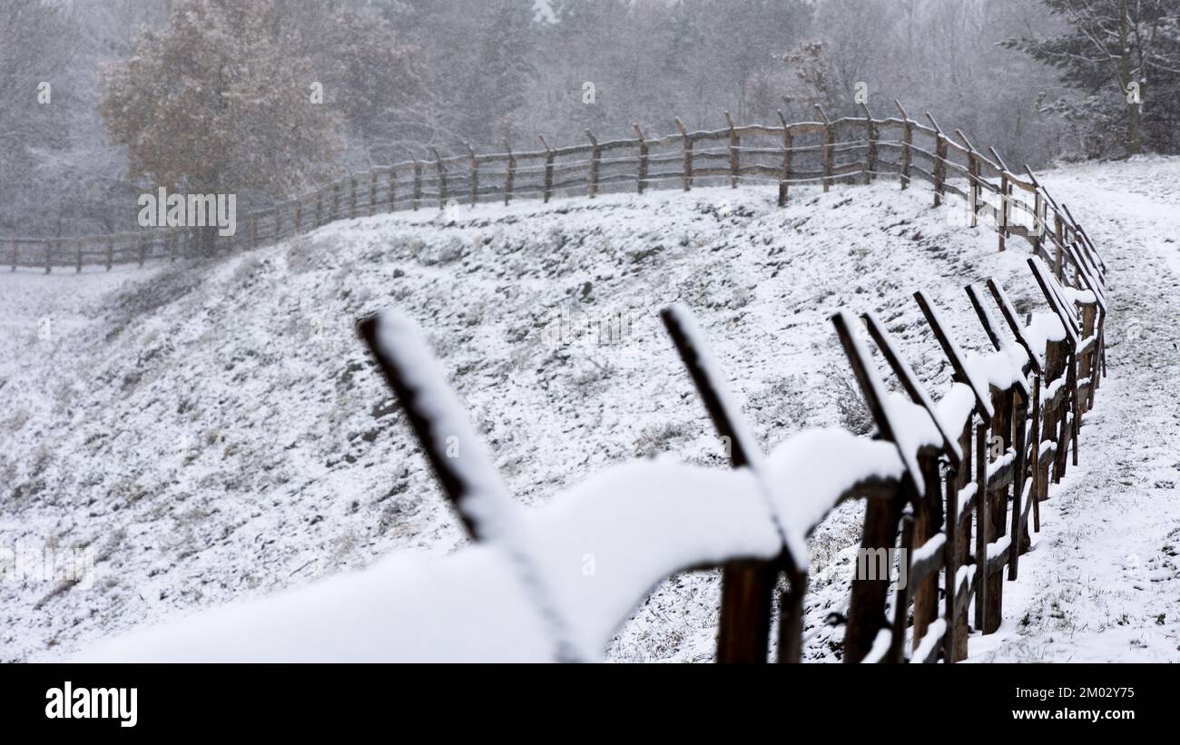 Wooden fence covered with a thin layer of the first snow. Rural ...