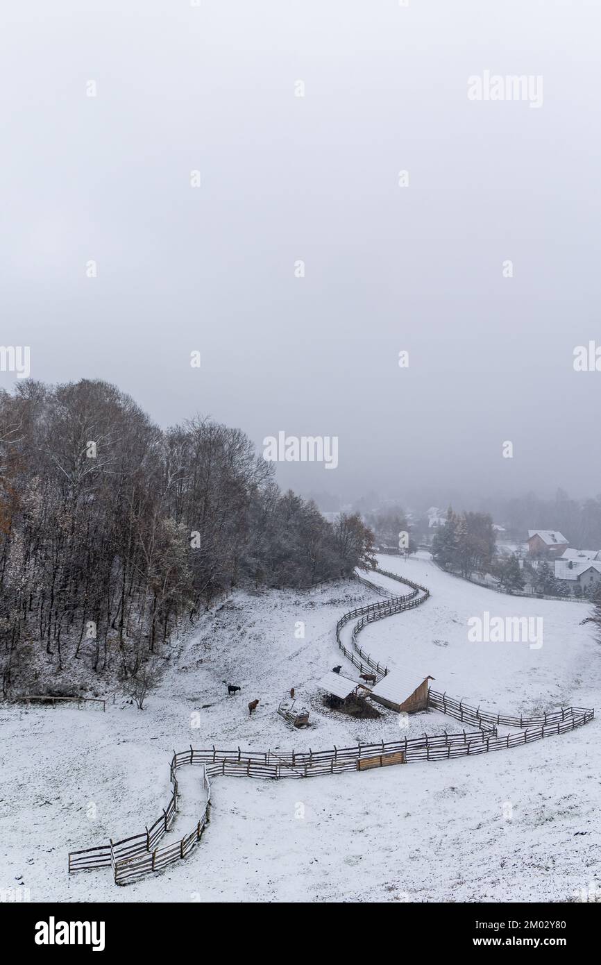 Wooden fence covered with a thin layer of the first snow. Rural ...
