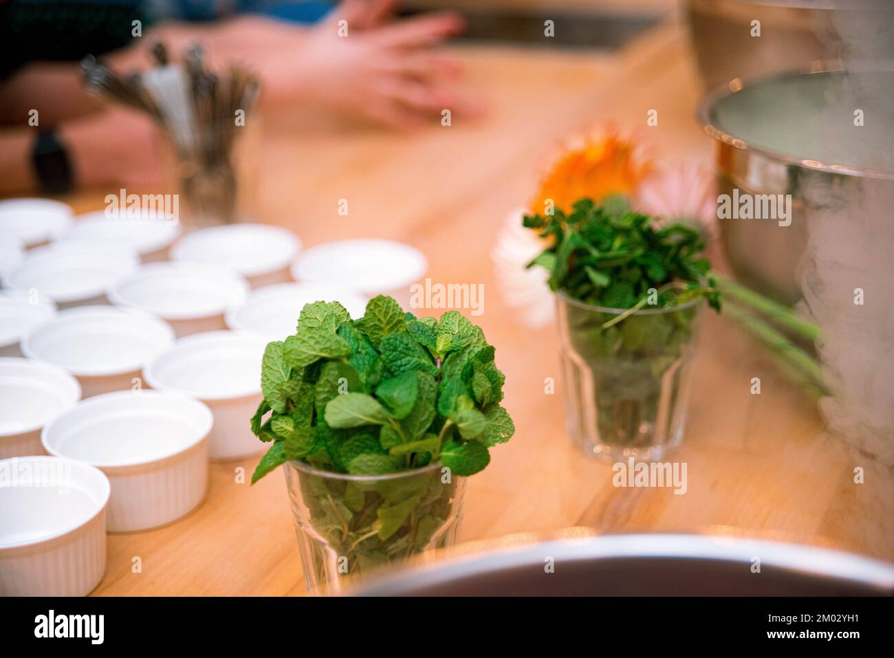 A group of empty ramekins prepared for dessert, a glass with fresh mint and nitrogen cloud Stock ...