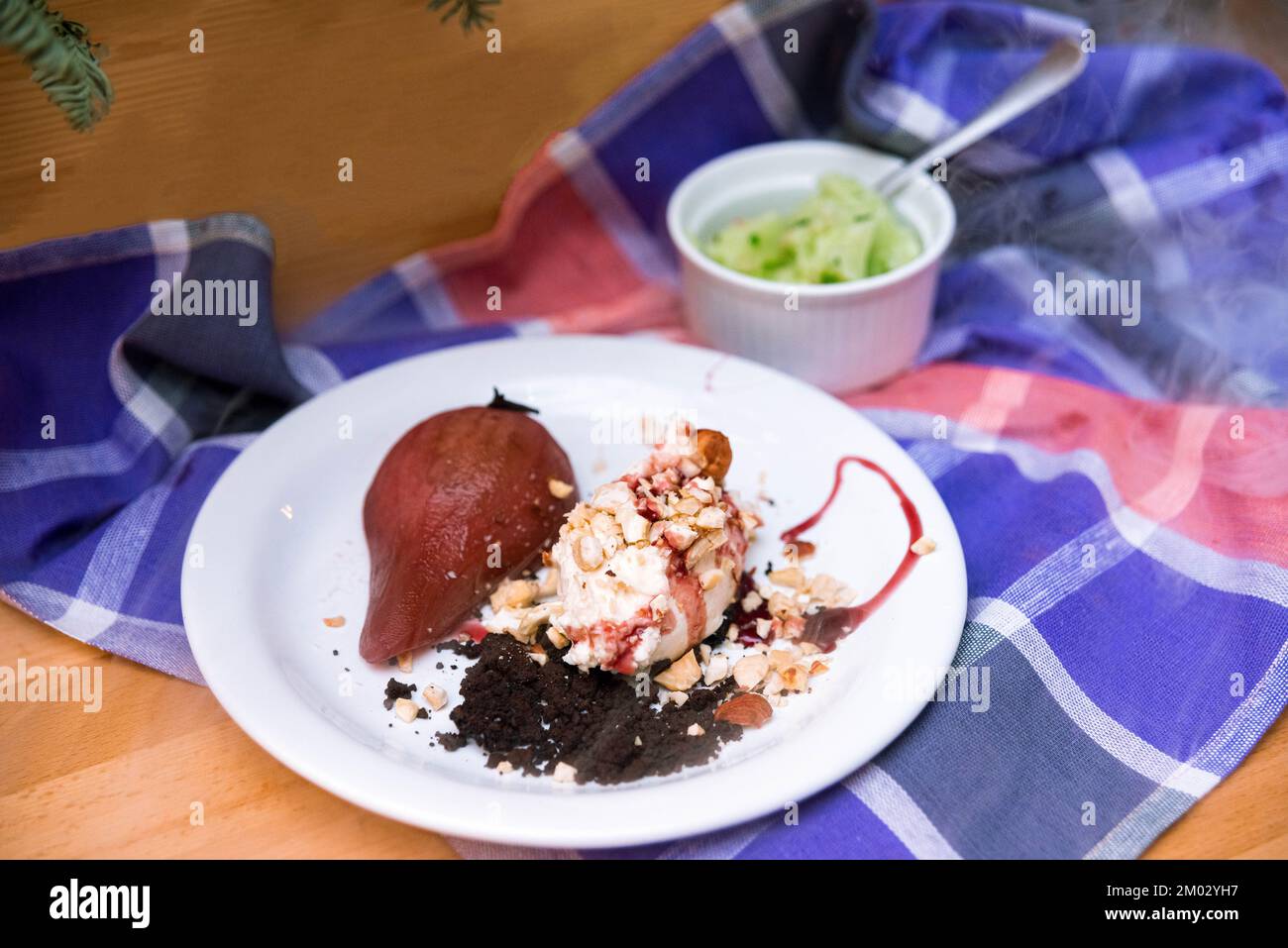 Ice cream dessert with nuts and drunken pears boiled in red wine ...