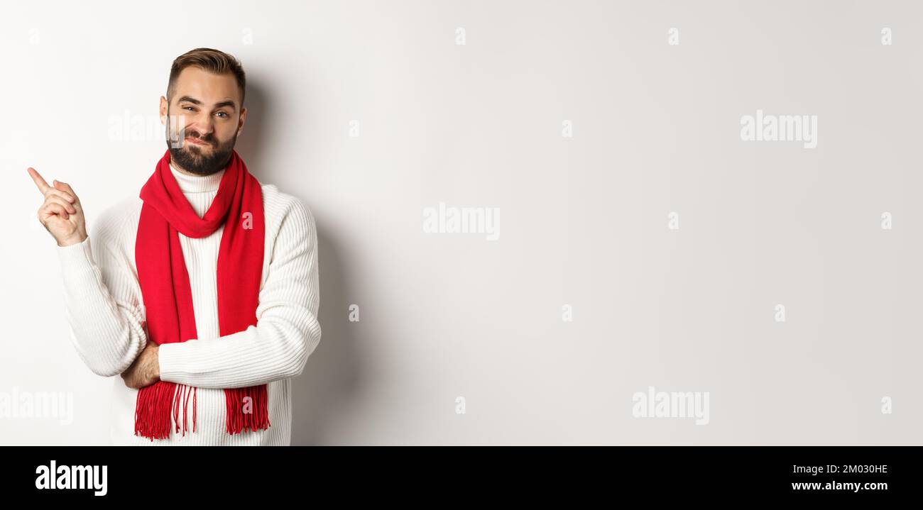 Christmas shopping and winter holidays concept. Skeptical young man ...