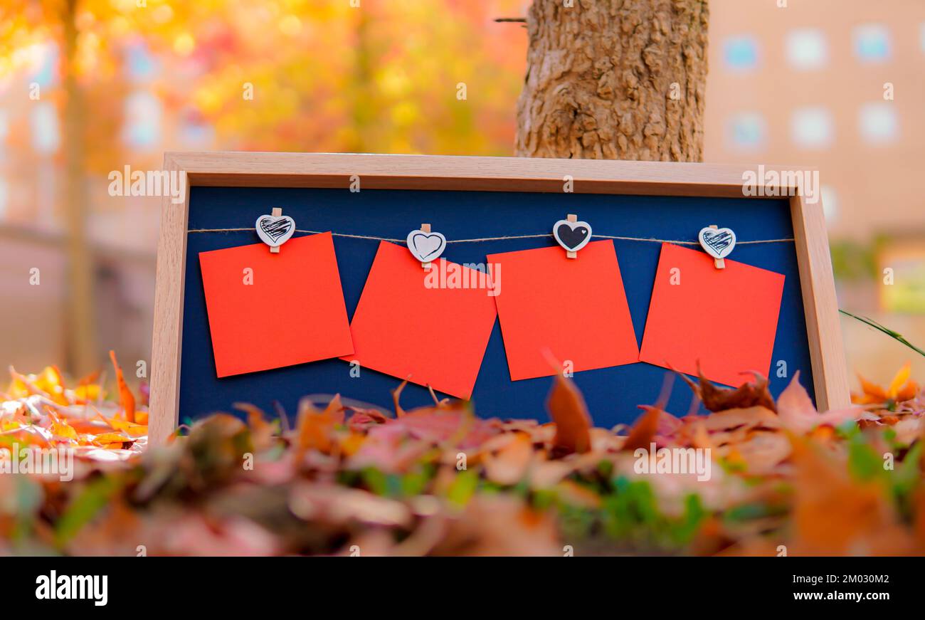 Photo frame with heart and red cardboard to write something on. Concept ...