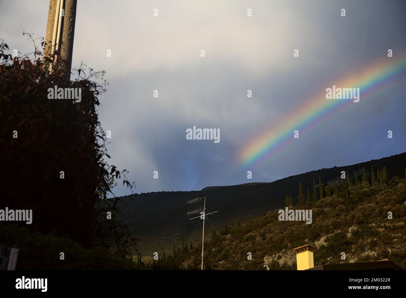 Rainbow over a mountain ridge and a olive tree grove at sunset Stock ...