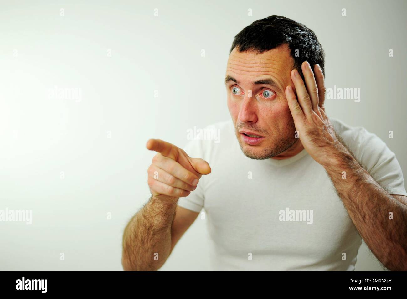 Adult handsome man with beard wearing white t-shirt over blue ...