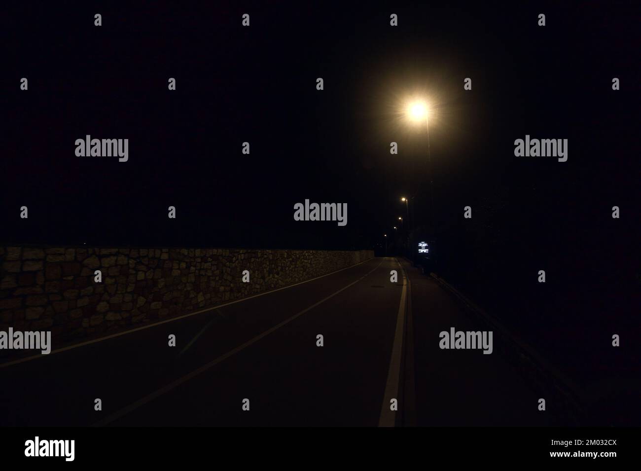 Country road with street lamps at night Stock Photo - Alamy