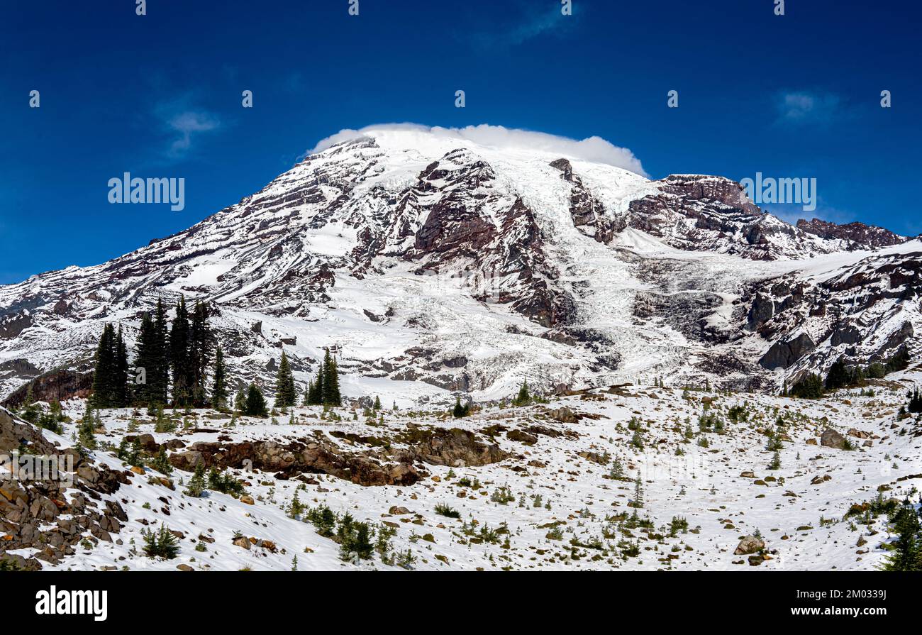 A view of snowy Mount Rainier near Seattle with blue sky and clouds on ...