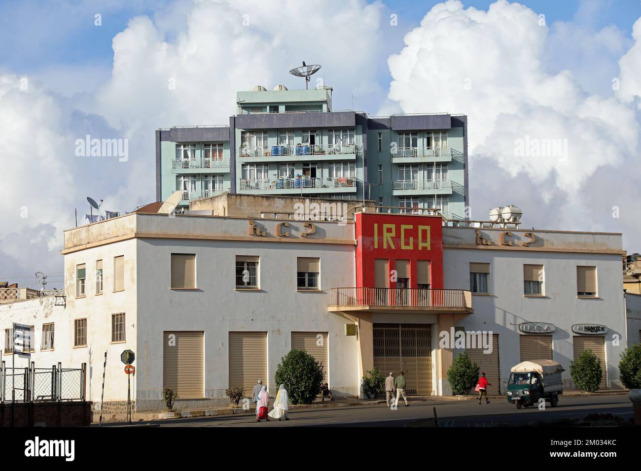 People walking past the IRGA building at Asmara in the early morning ...