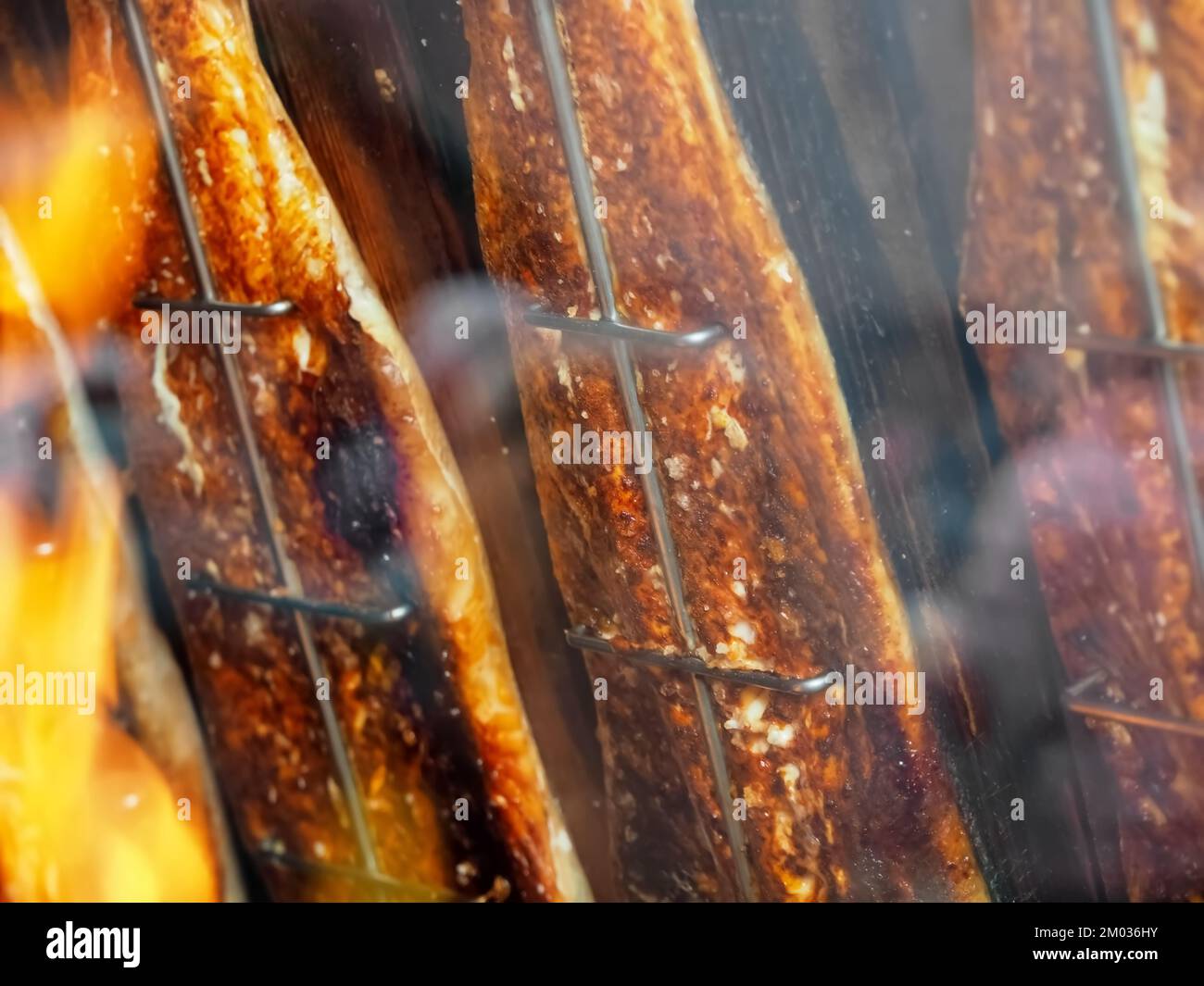 Flamed salmon on a grill and fire Stock Photo - Alamy