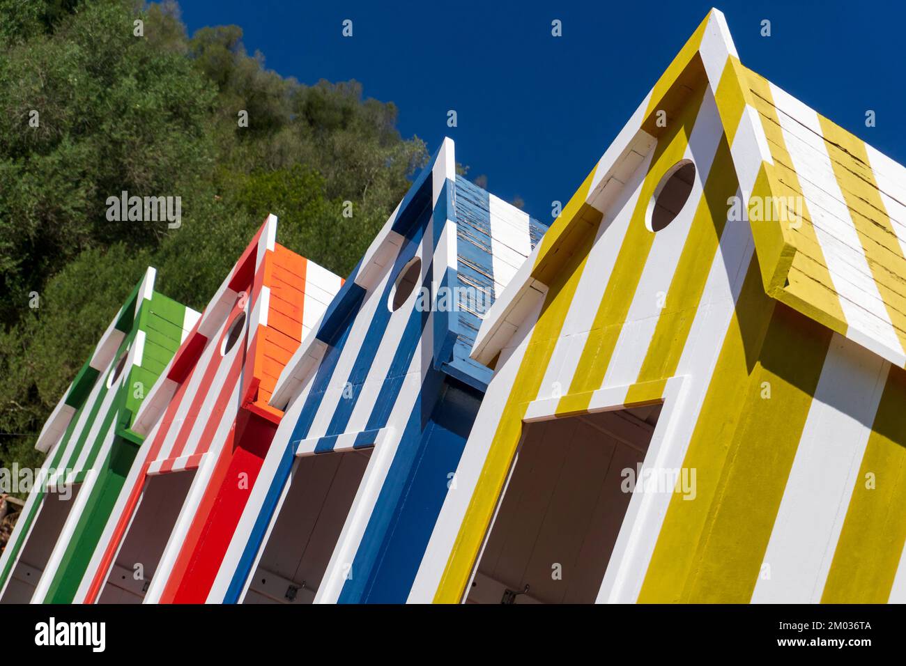 Colorful striped changing houses on the beach Stock Photo - Alamy