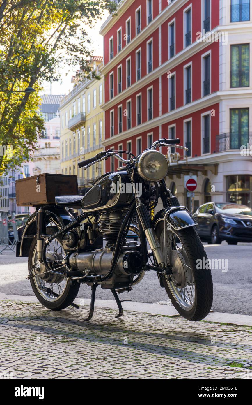 Black retro motorcycle parked in downtown Stock Photo - Alamy