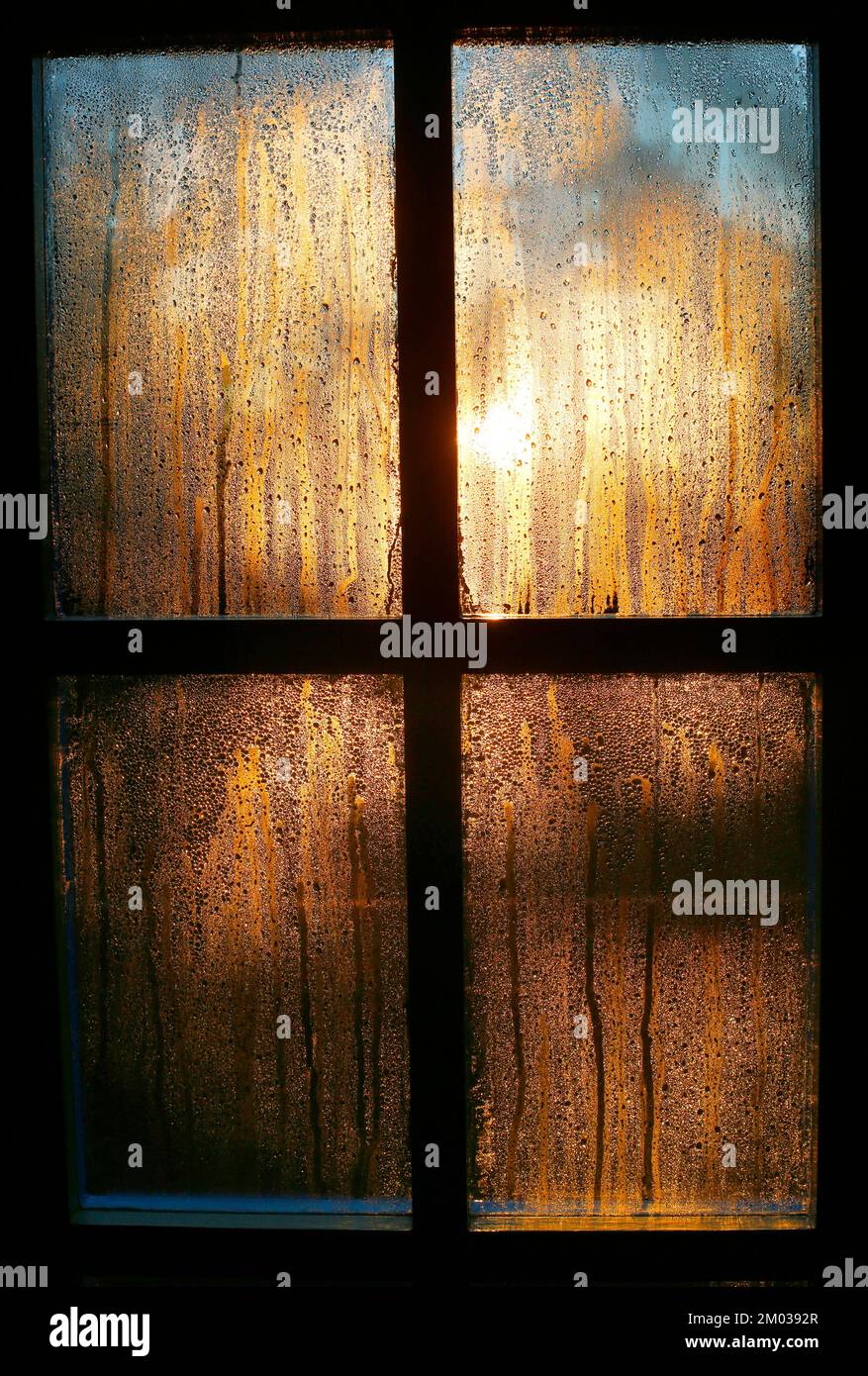 Sunrise shining through a condensation covered bedroom window Stock ...