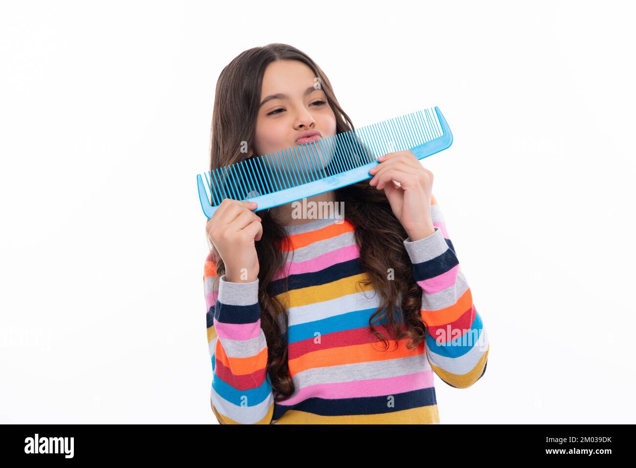Funny face. Teenager girl with long hair holding comb hairbrush for ...