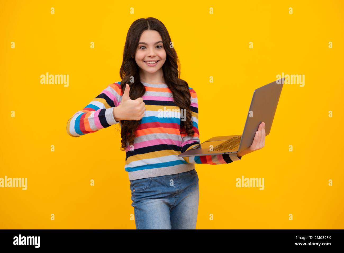Young girl student hold computer. Funny pupil with laptop isolated on ...