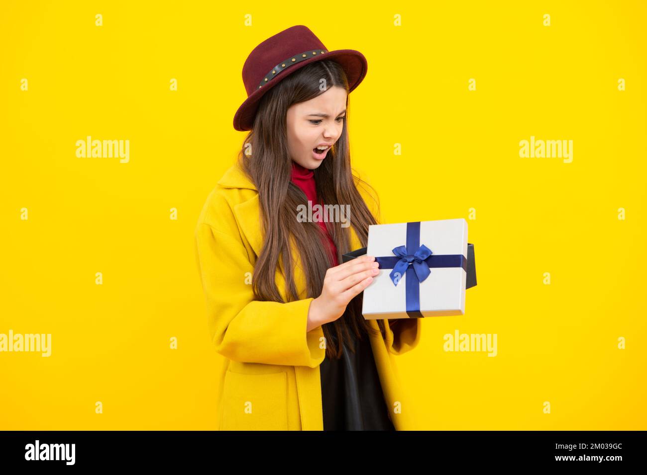 Emotional teenager child hold gift on birthday. Funny kid girl holding ...