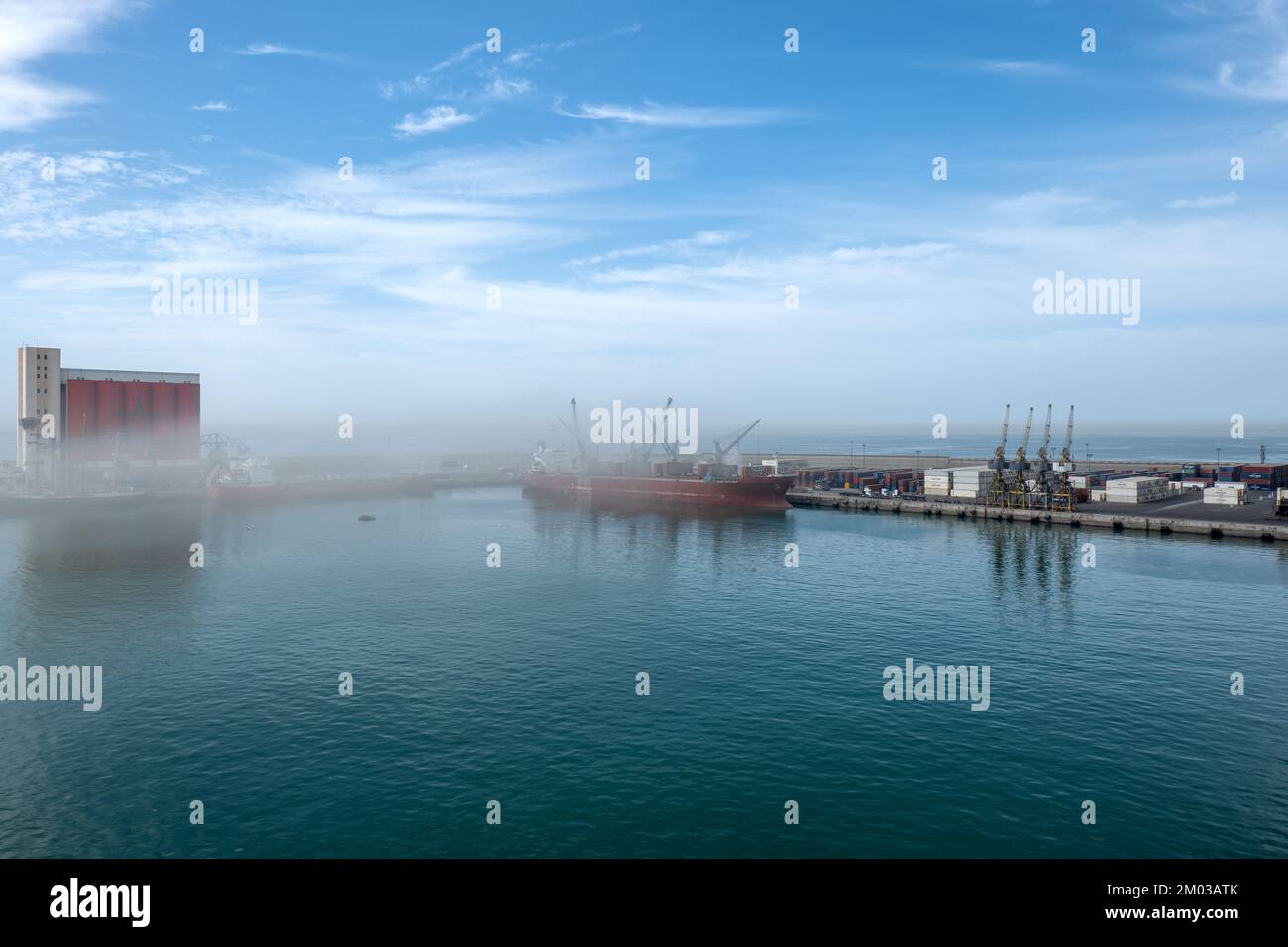 Industrial port of Agadir with ship at dock (poor visibility due to ...