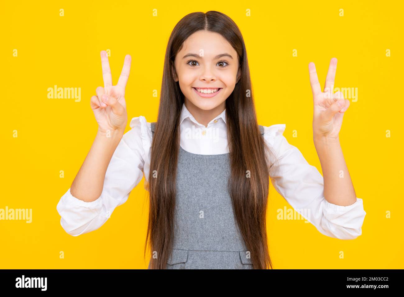 Cute teen girl showing fingers doing victory sign. Number two, v sign ...