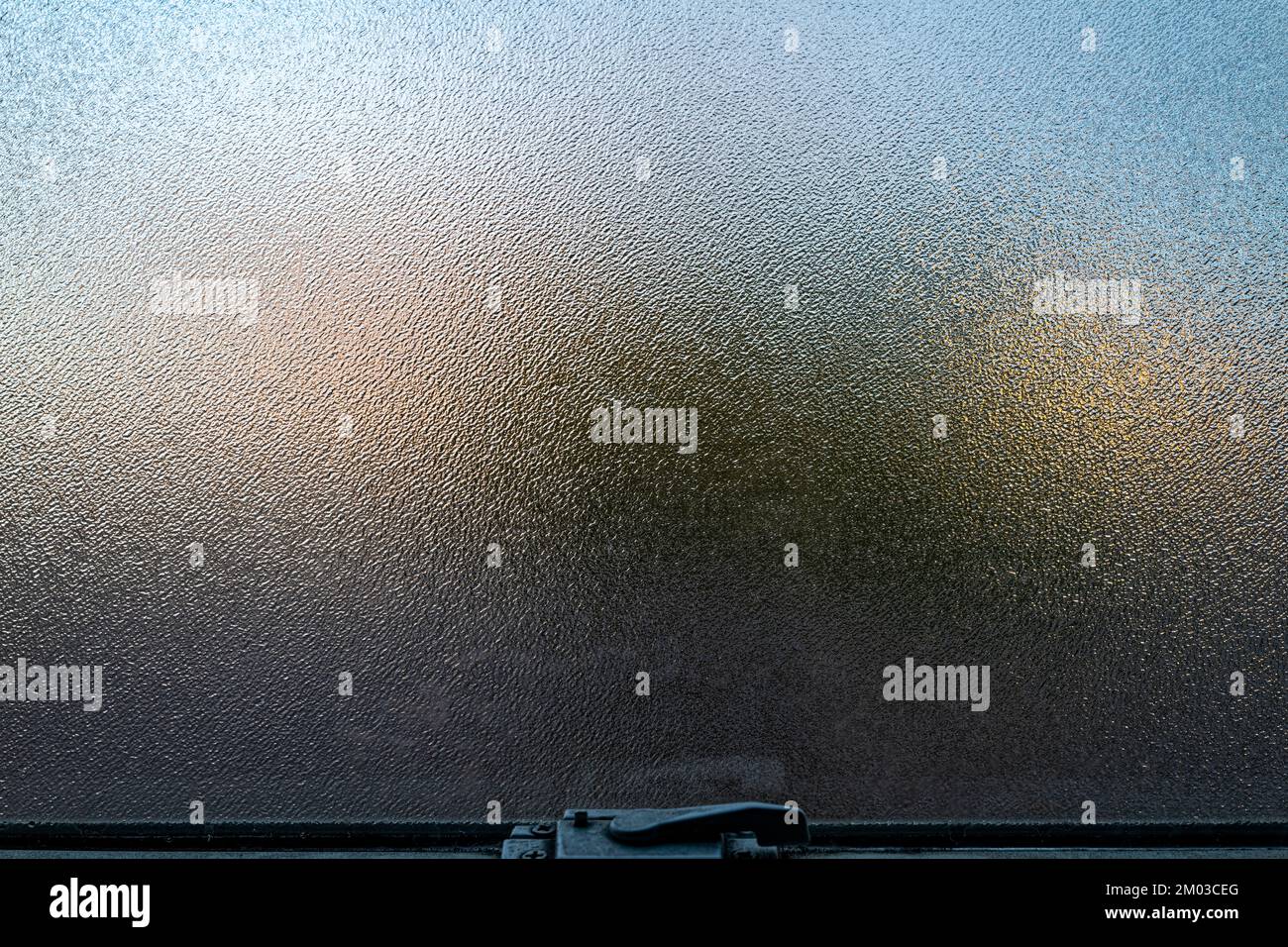 Close up of shadows and colors reflected on a frosted glass window ...