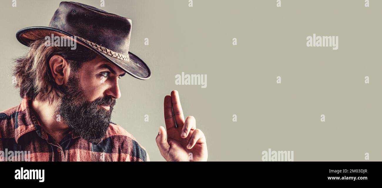 Portrait of cowboy in hat. Portrait of man wearing cowboy hat, gun ...