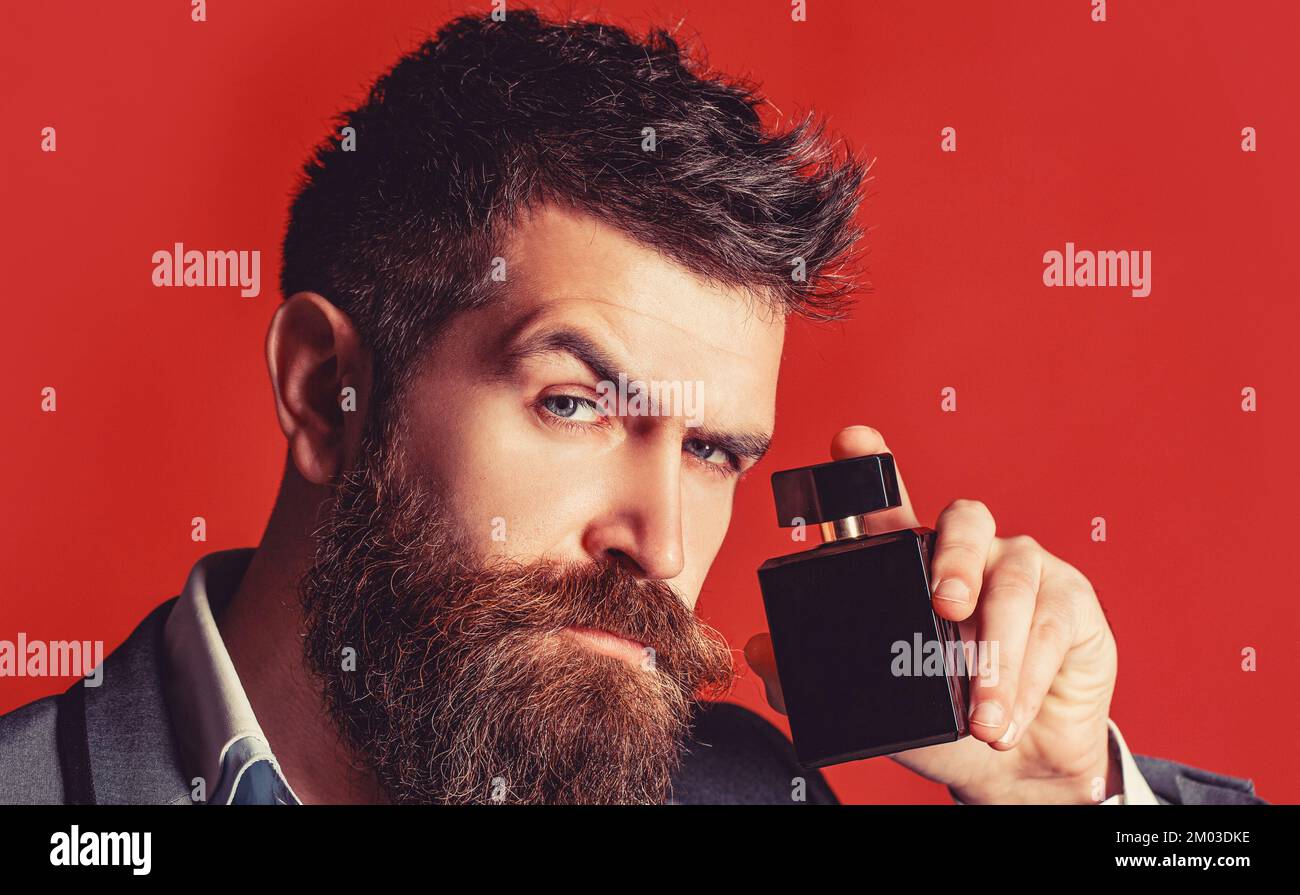 Masculine Perfumery Bearded Man In A Suit Male Holding Up Bottle Of Perfume Man Perfume