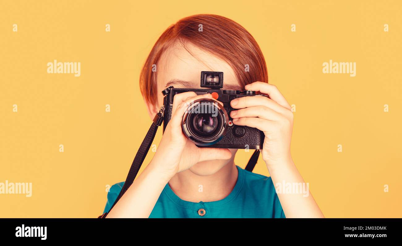 Child in studio with professional camera. Boy using a cameras. Baby boy ...