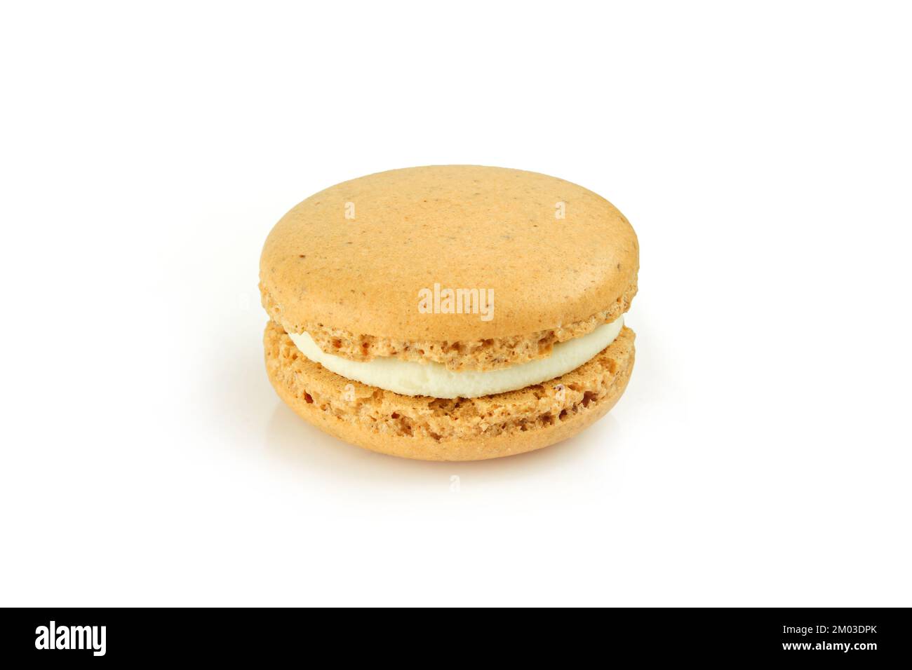 Single brown macaroon with white filling cream isolated on white ...