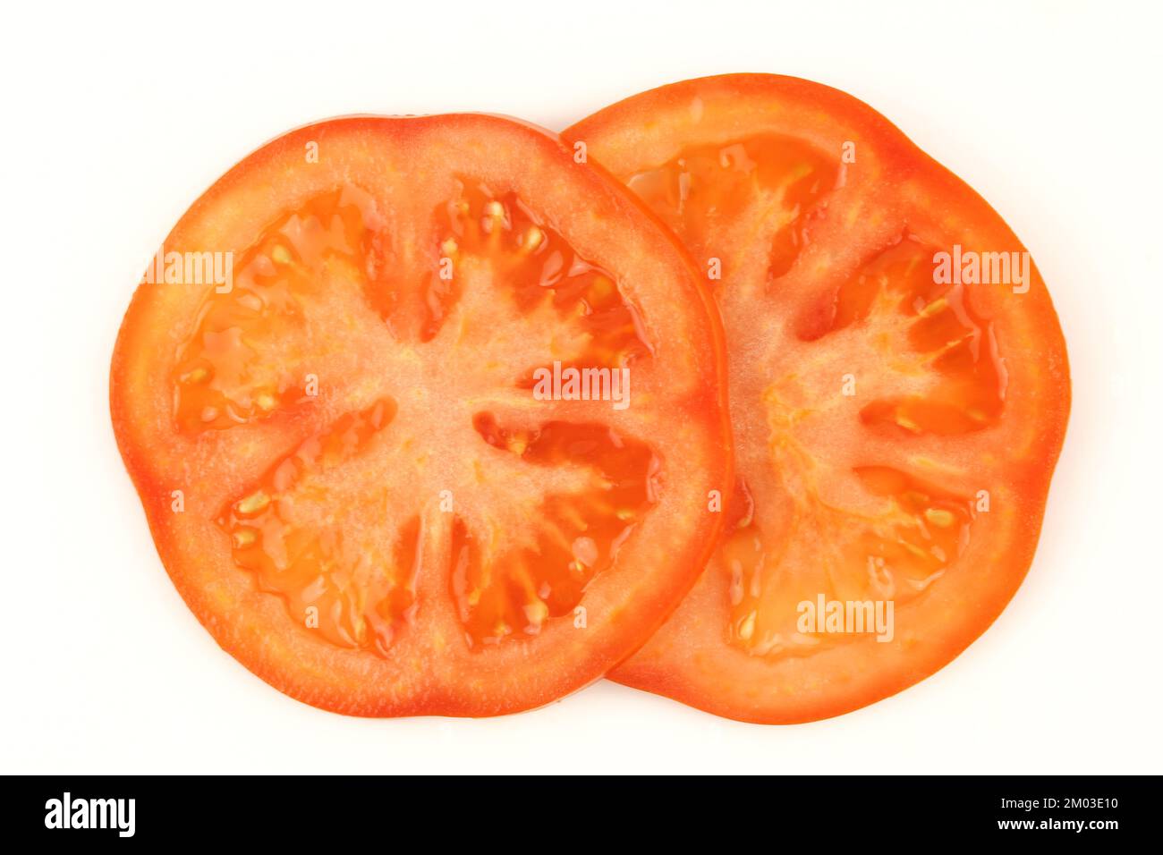 Two slices of tomato isolated on white background Stock Photo - Alamy